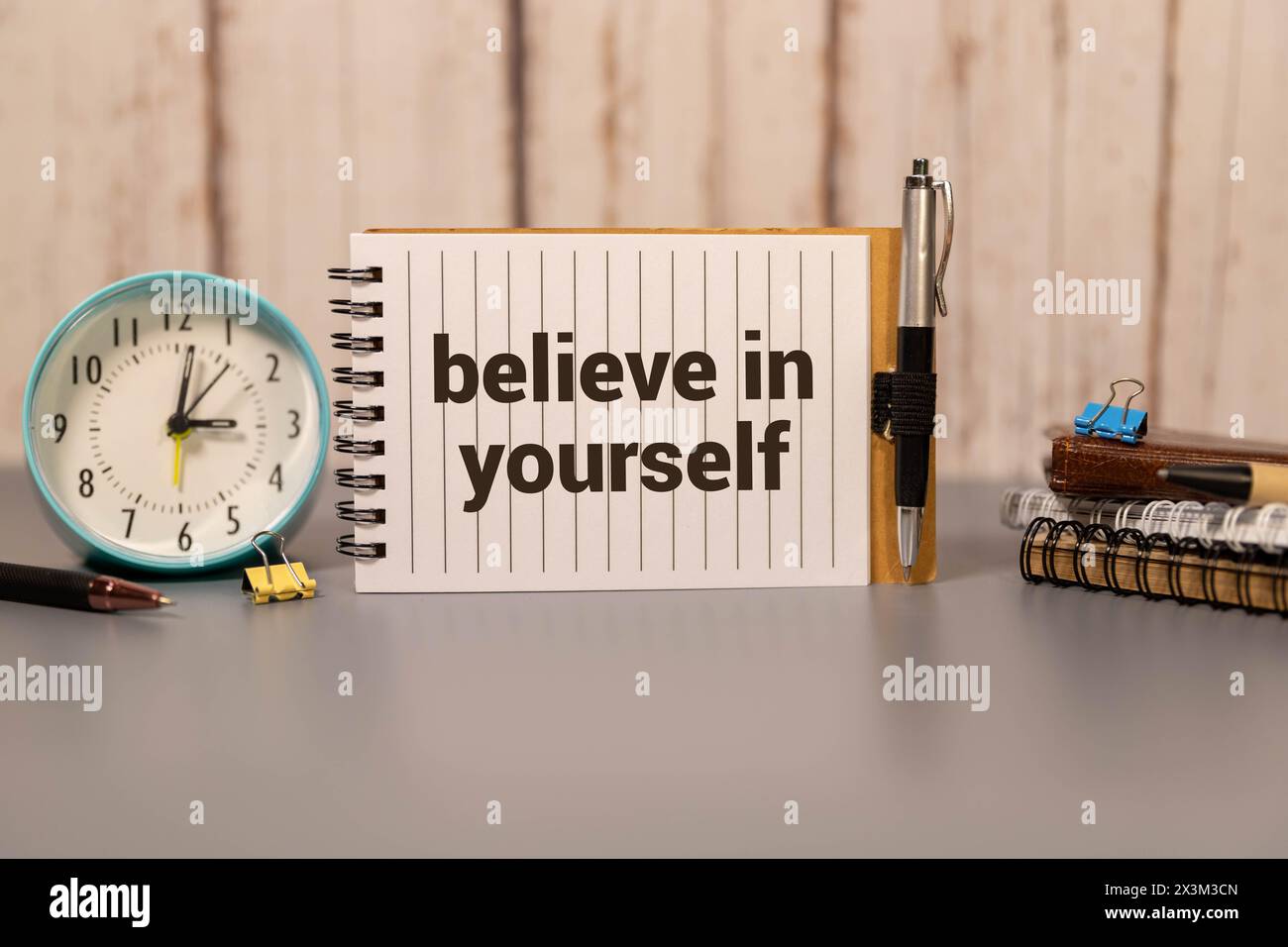 Believe In Yourself, written on an yellow sticky note on a cork ...