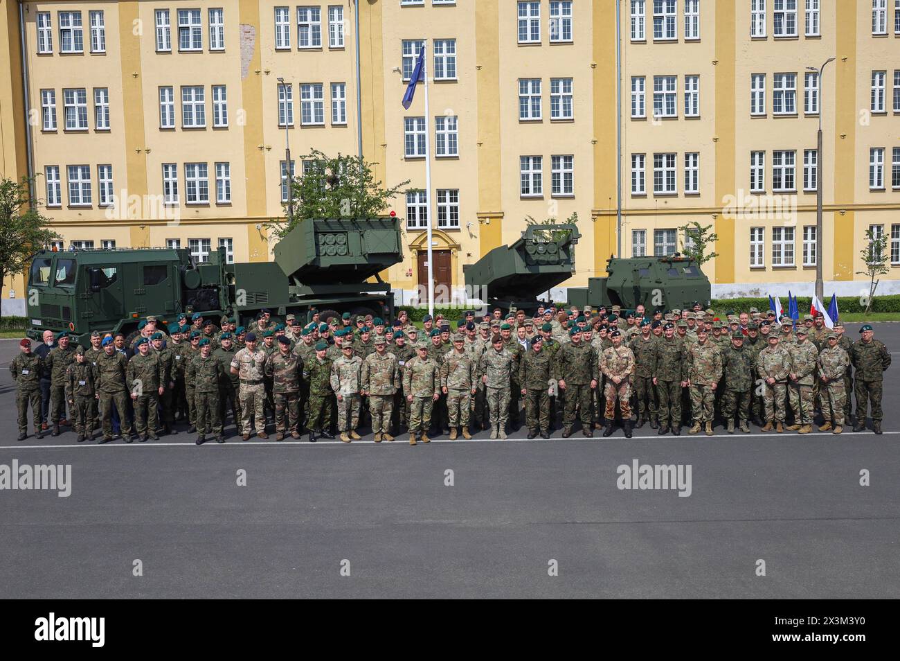 Participants stand for a group photo in Torun, Poland, April 25, 2024 ...