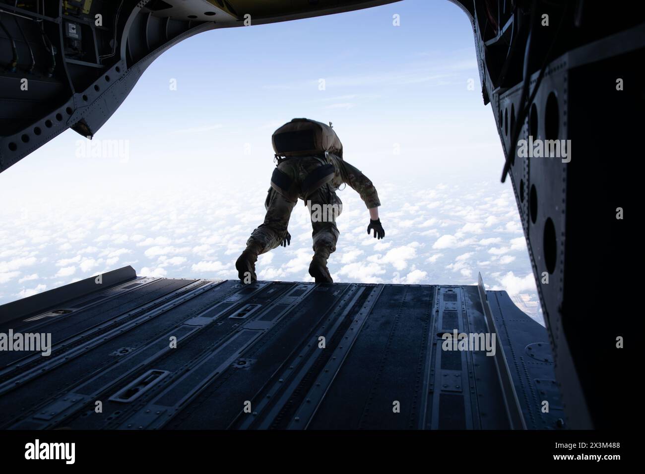 A U.S. Army Soldier conducts a free fall airborne jump out of a CH-47 ...