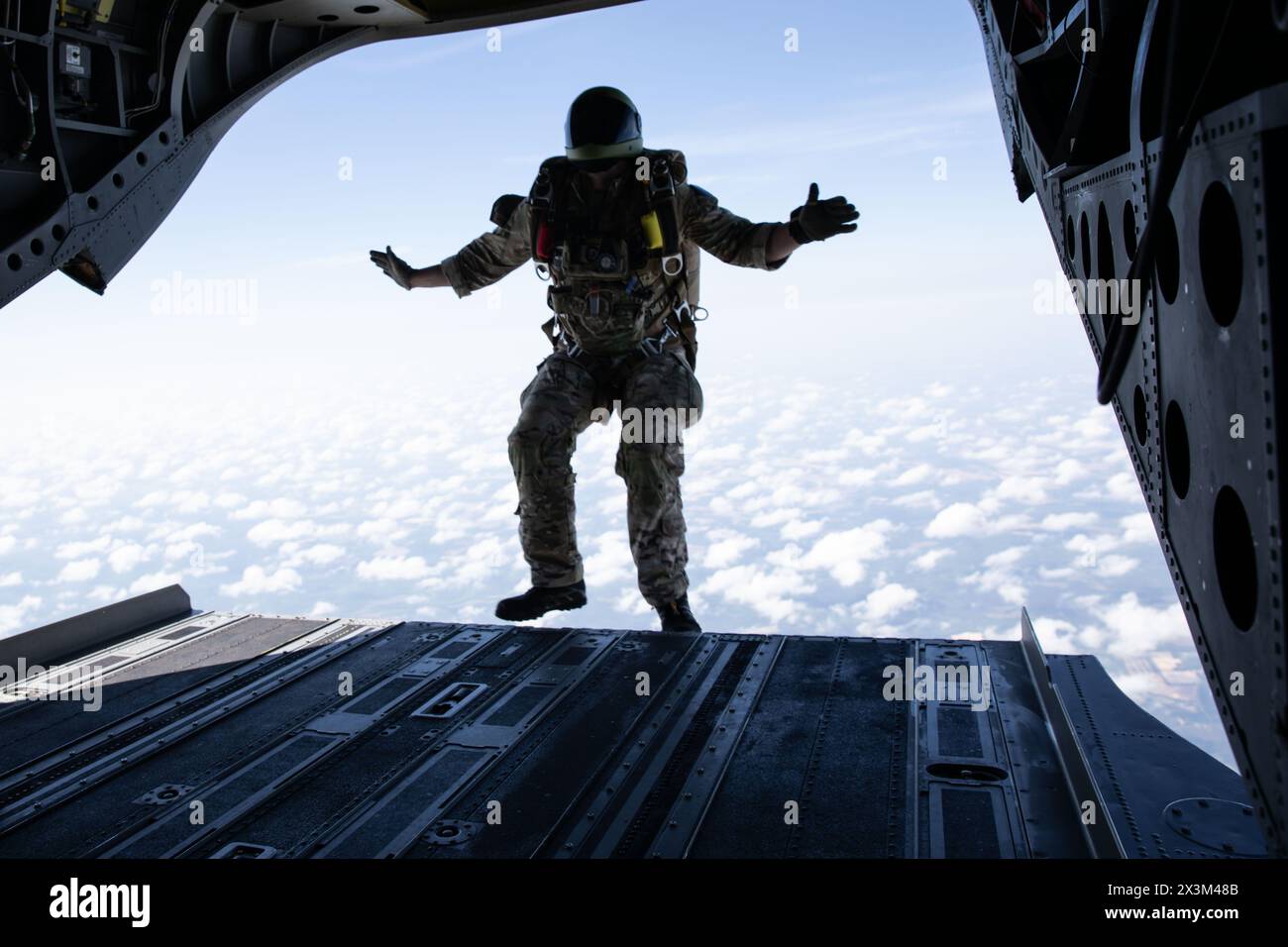 A U.S. Army Soldier conducts a free fall airborne jump out of a CH-47 ...