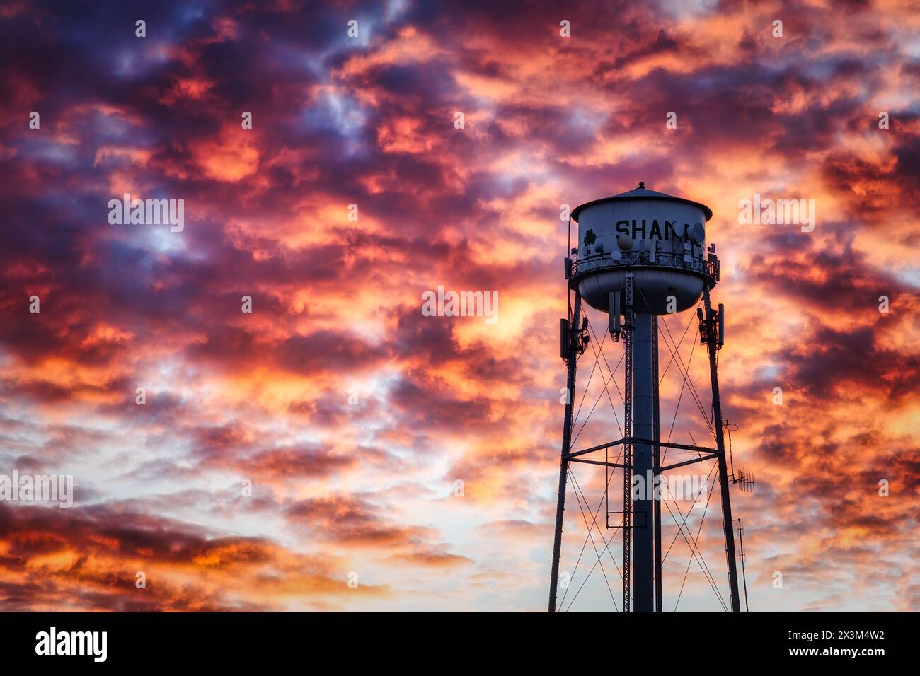 The winter sun sets on Route 66 behind the water tower in Shamrock ...