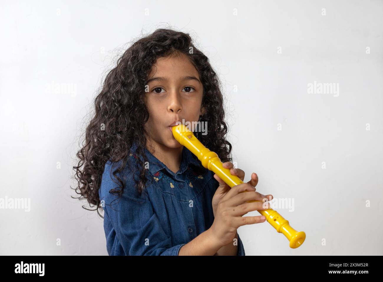 Latin American girl playing with skill the soprano recorder Stock Photo ...