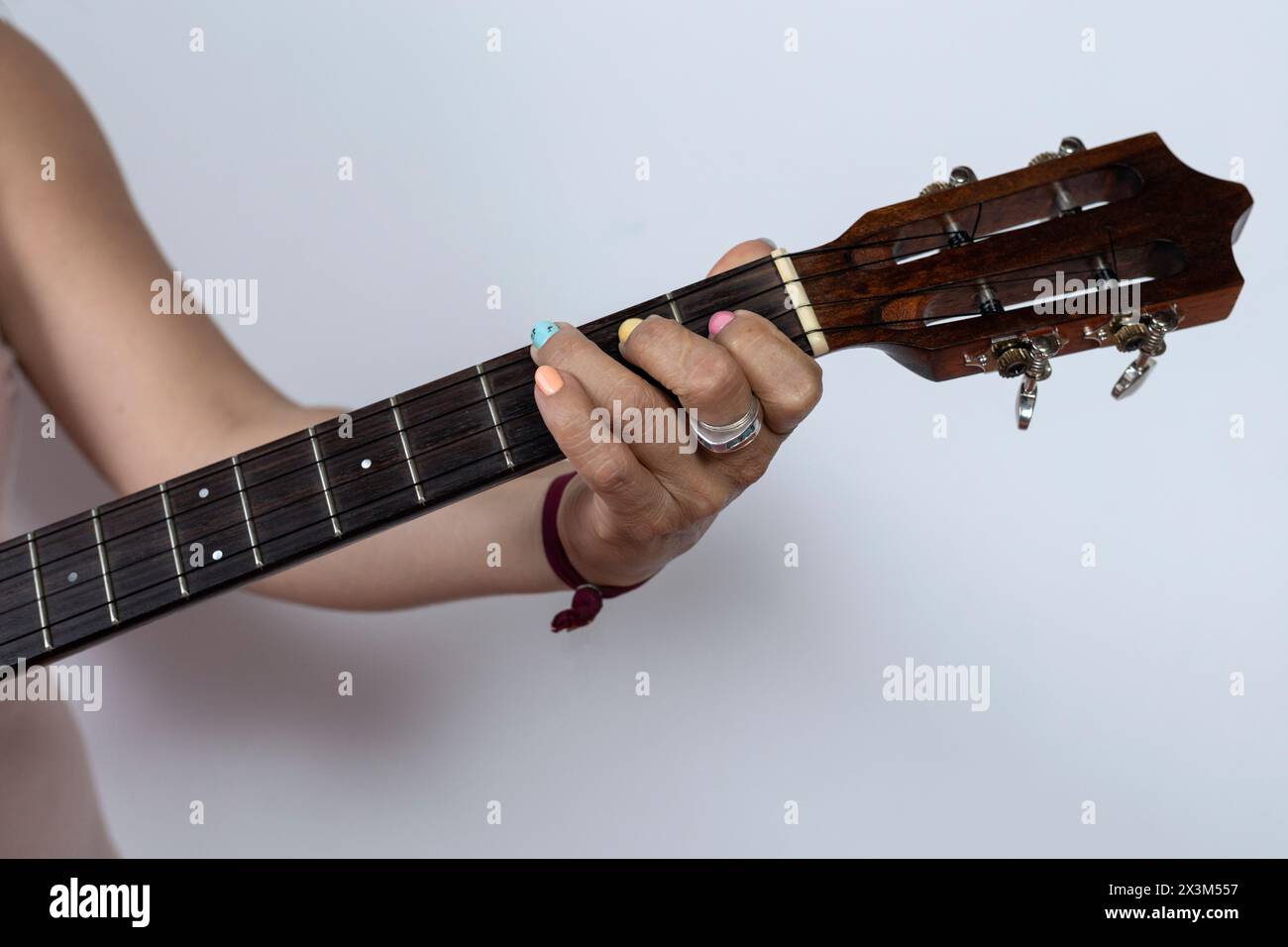 Woman's hands playing a major chord on a cuatro, Venezuelan folk ...