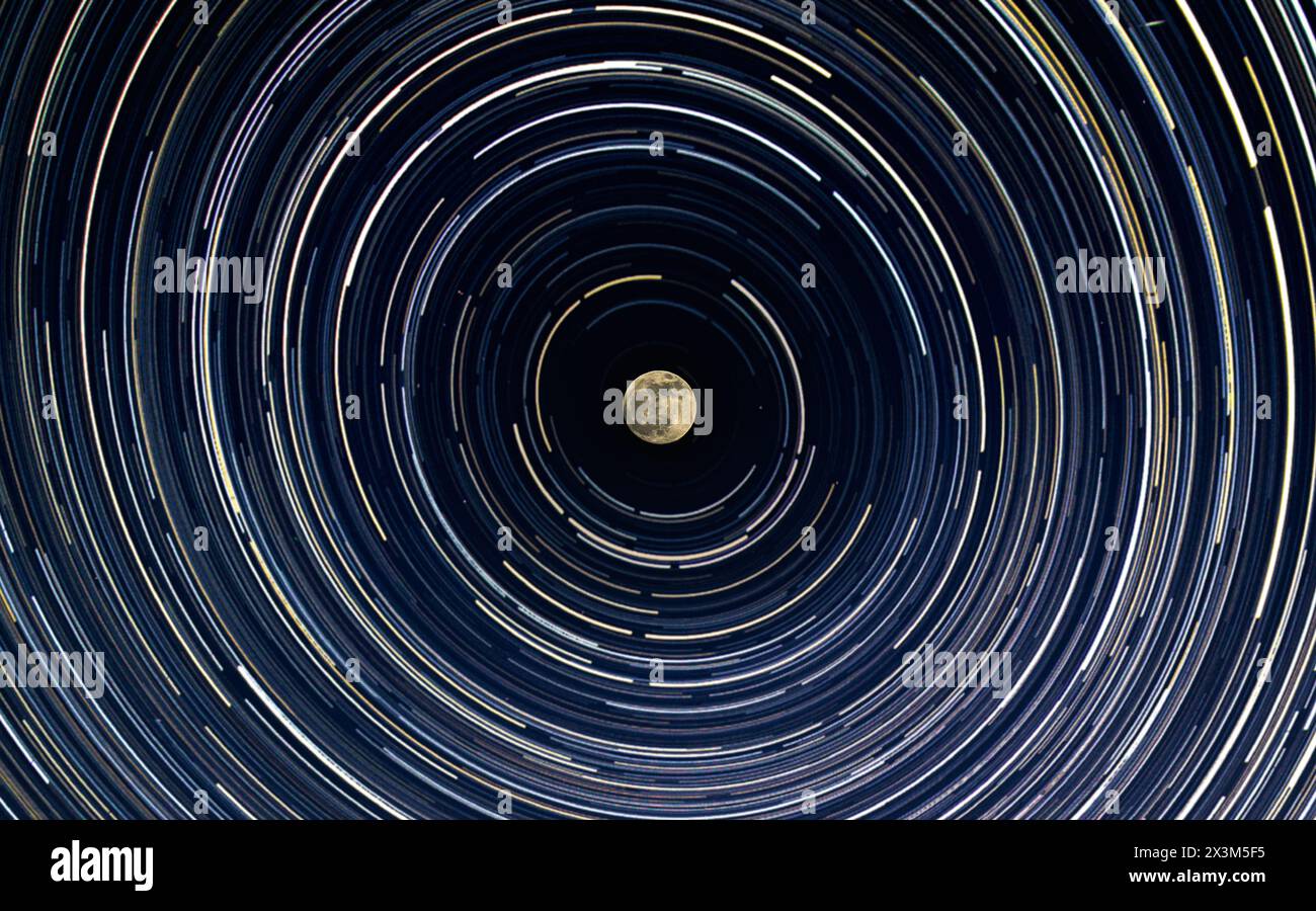 Mesmerizing view of the full moon embraced by swirling star trails, a ...