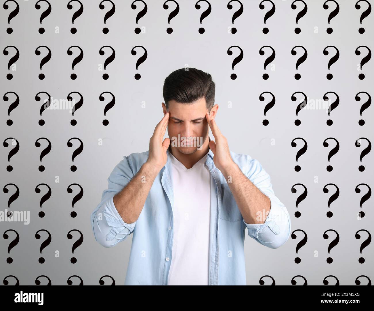 Amnesia. Confused man and question marks on light background Stock ...
