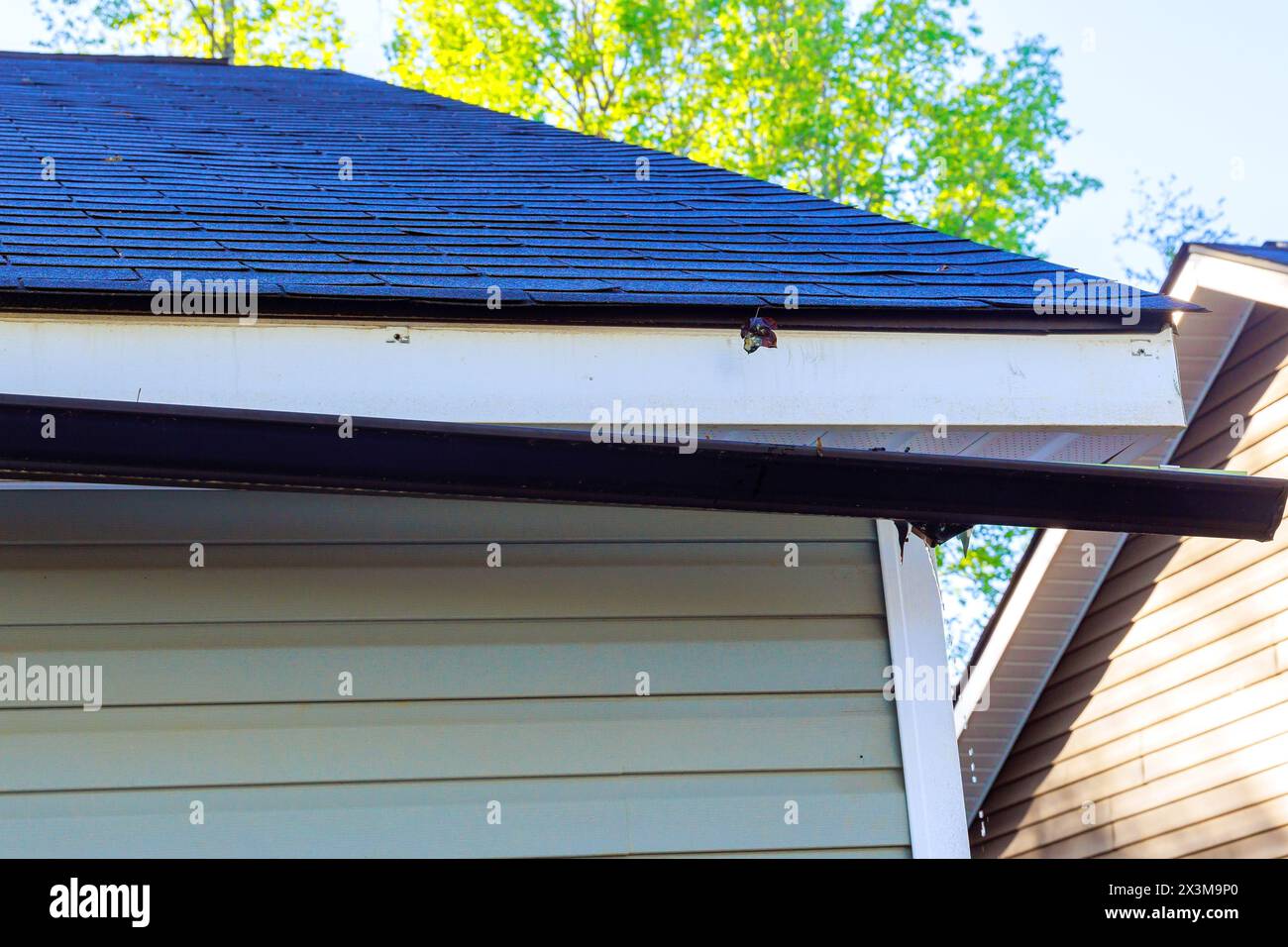 Broken rain gutter on roof of house after hurricane damages Stock Photo ...