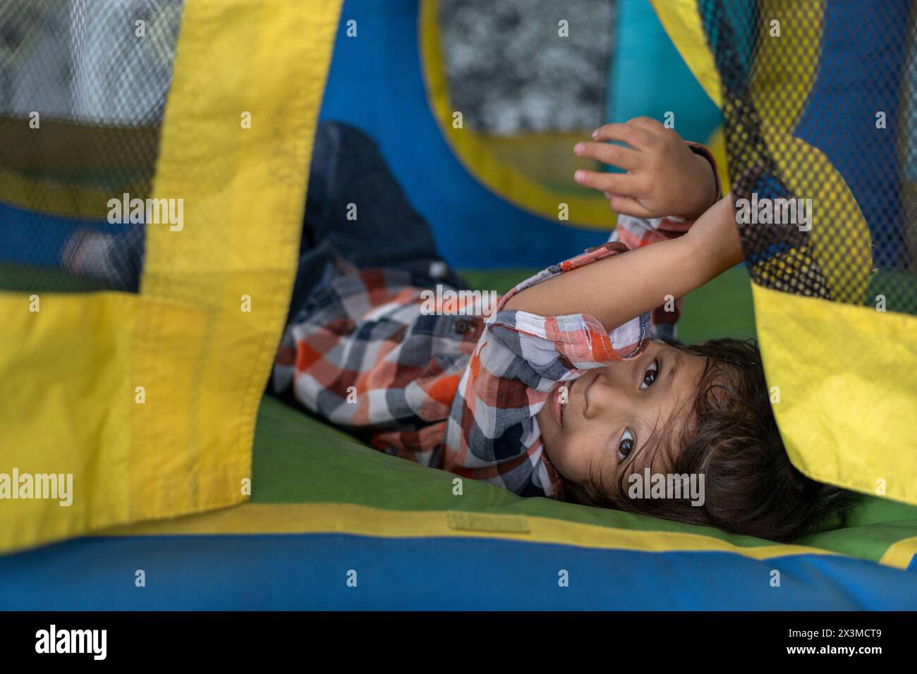 Latin American boy has fun in a bouncy castles Stock Photo - Alamy