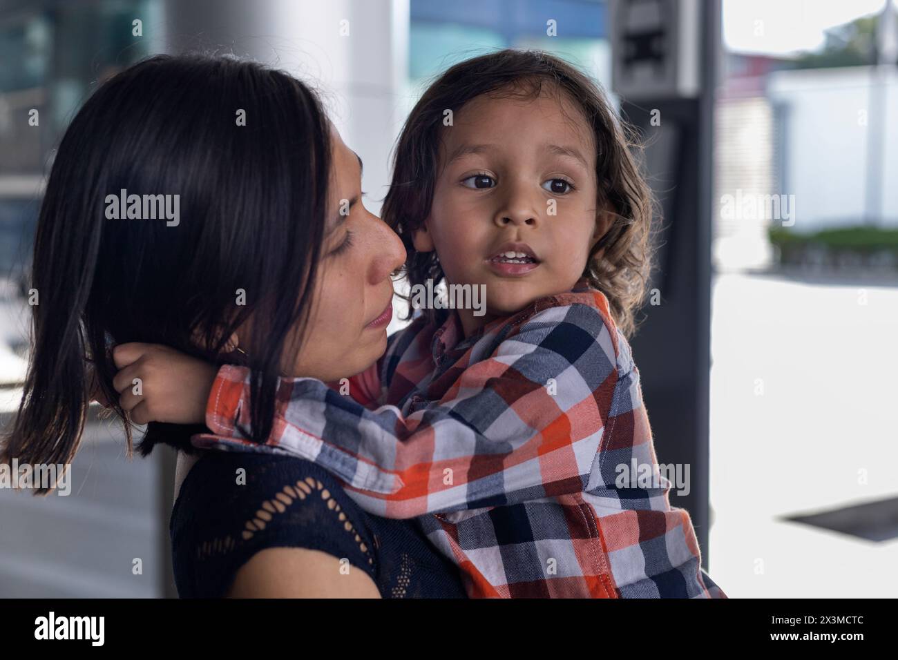 Mom And Her Latin American Son Show Their Love With Hugs And Smiles