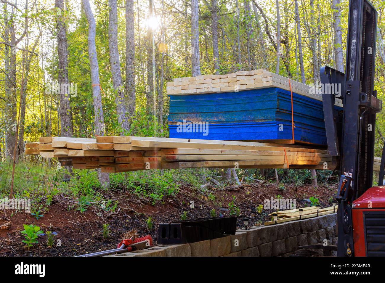 An employee of construction company using forklift to deliver building ...