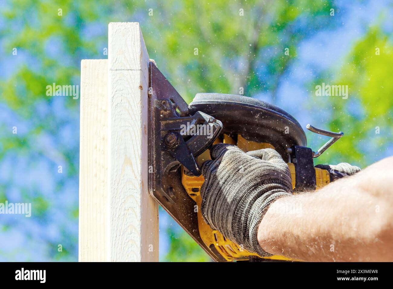 Process of cutting wooden beams using handsaw by woodworking carpenter ...