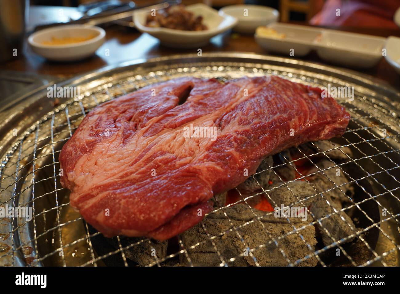 Thick beef grilled directly on a charcoal grill Stock Photo - Alamy