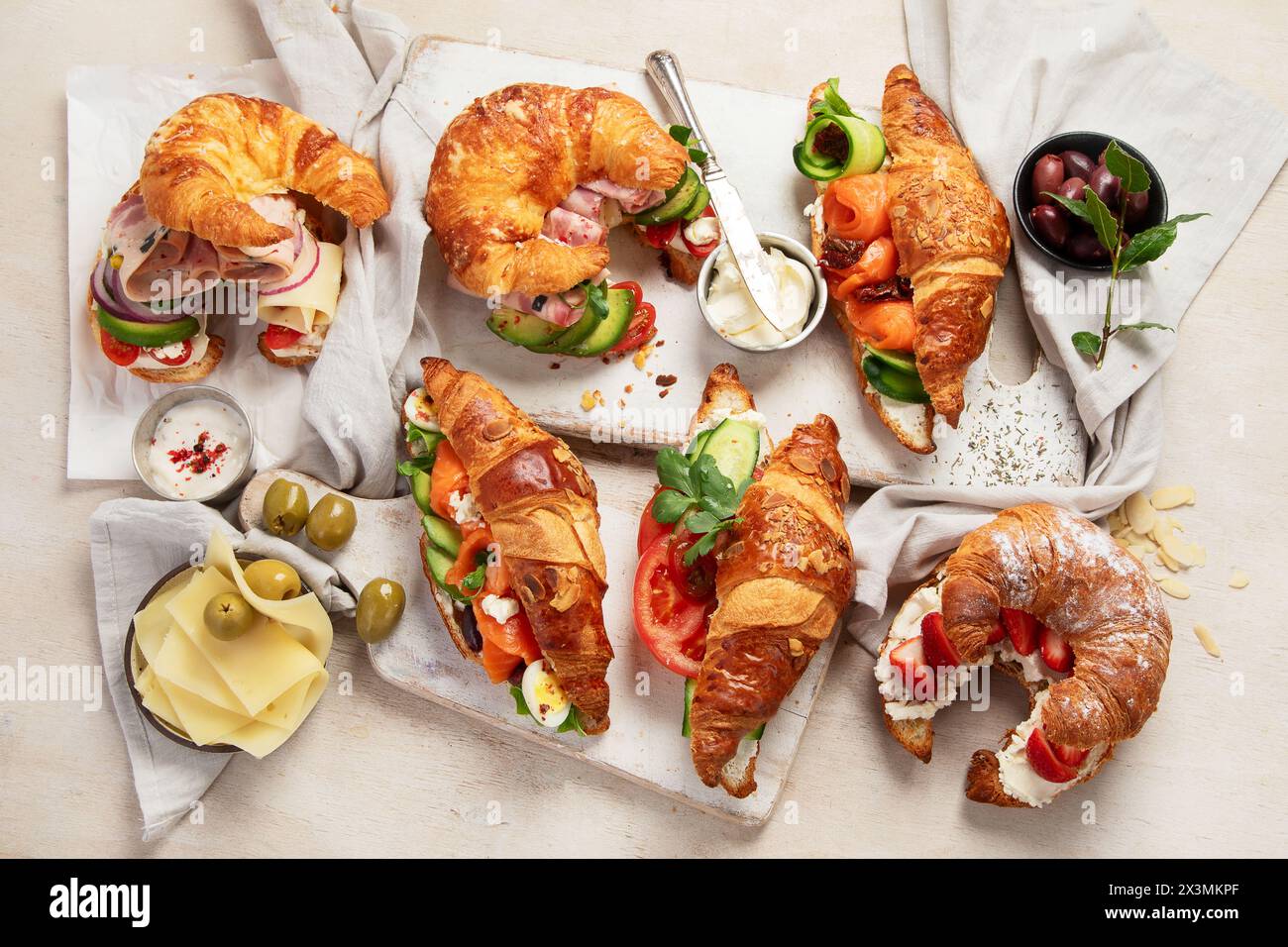 Set of tasty sweet and salty croissant sandwiches on white background ...