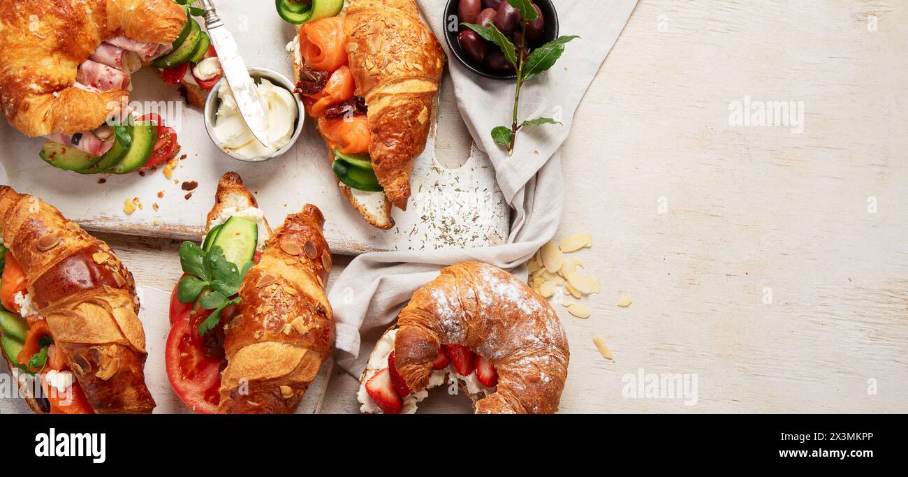 Set of tasty sweet and salty croissant sandwiches on white background ...