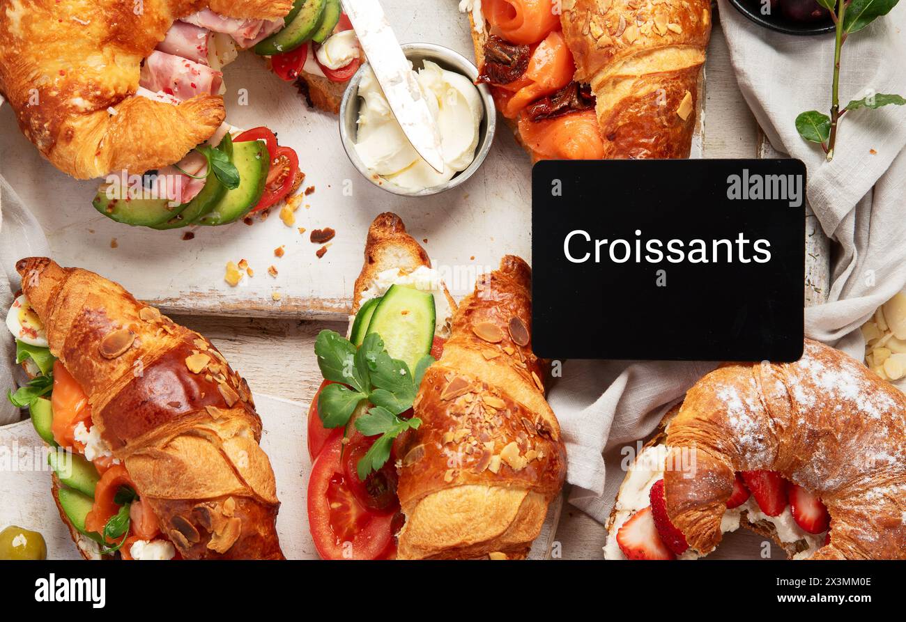 Set of tasty sweet and salty croissant sandwiches on white background ...