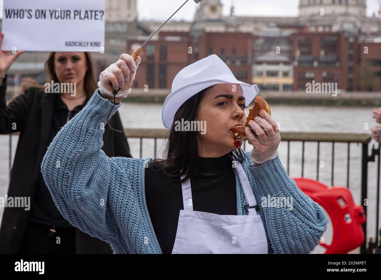 London, UK. 27th Apr, 2024. A protester pretends to eat a burger during ...