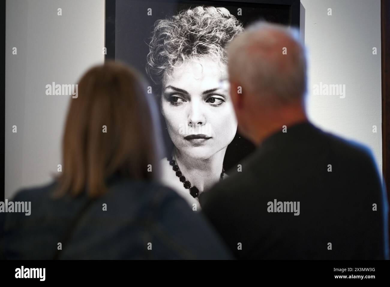 Guest look at a portrait of actress Michelle Pfeiffer by photographer ...
