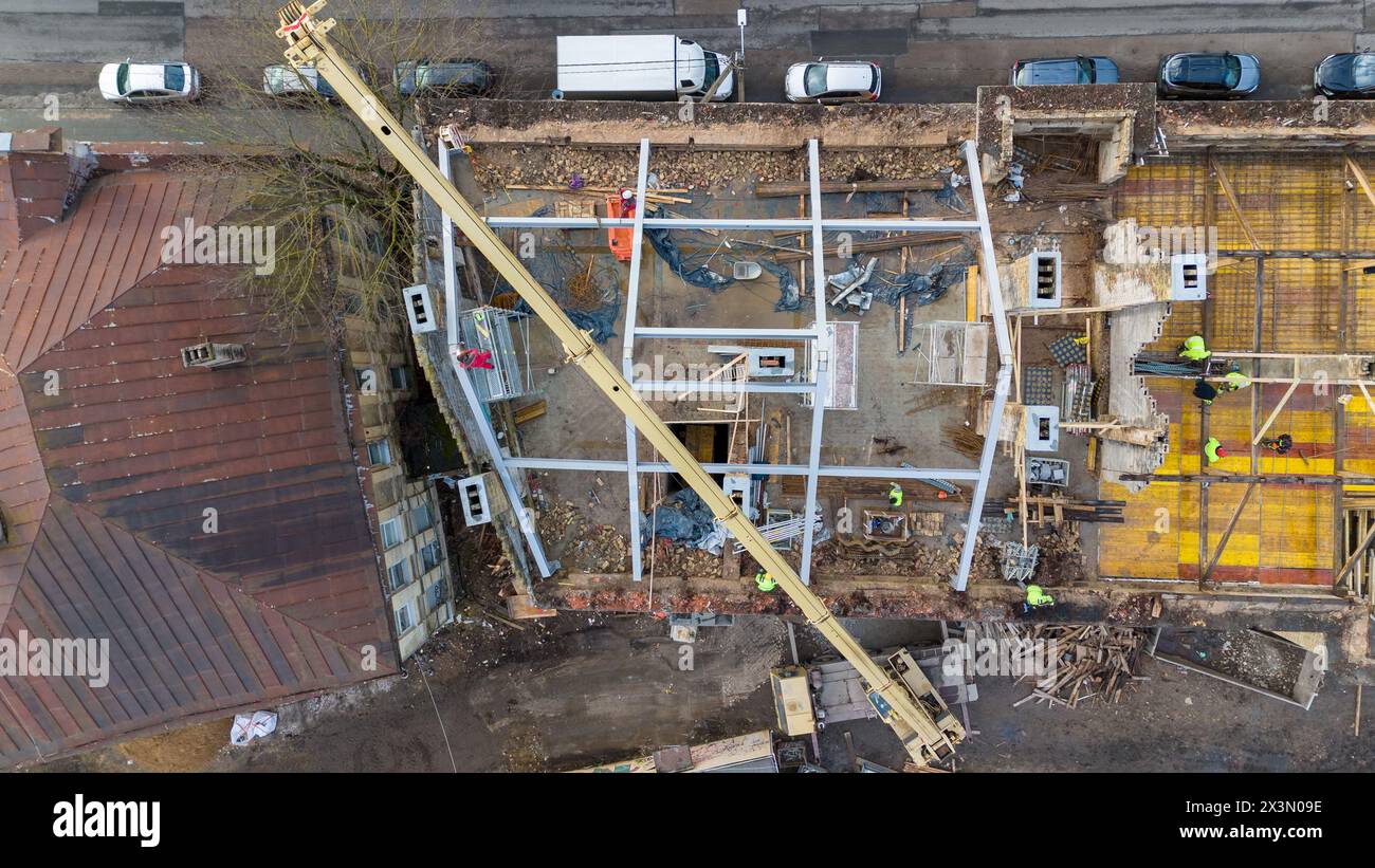Drone photography of construction workers building new rooftop on old ...