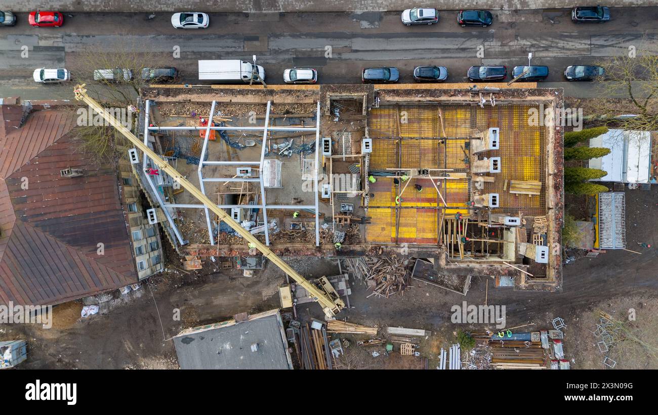 Drone photography of construction workers building new rooftop on old ...