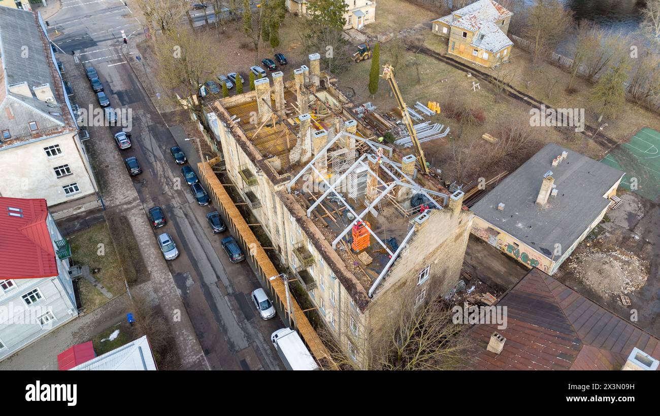 Drone photography of construction workers building new rooftop on old ...