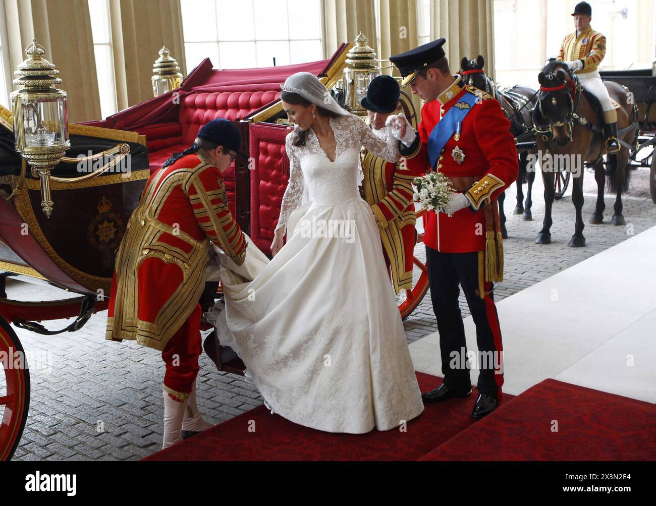File photo dated 29/04/11 of Prince William (right) helping his bride ...