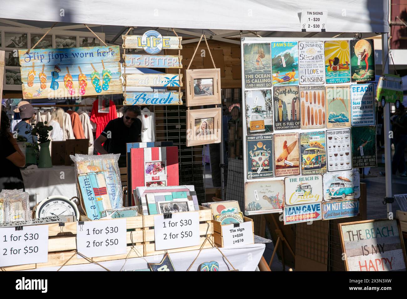 Timber and metal beach hanging signs for sale at a market stall in ...
