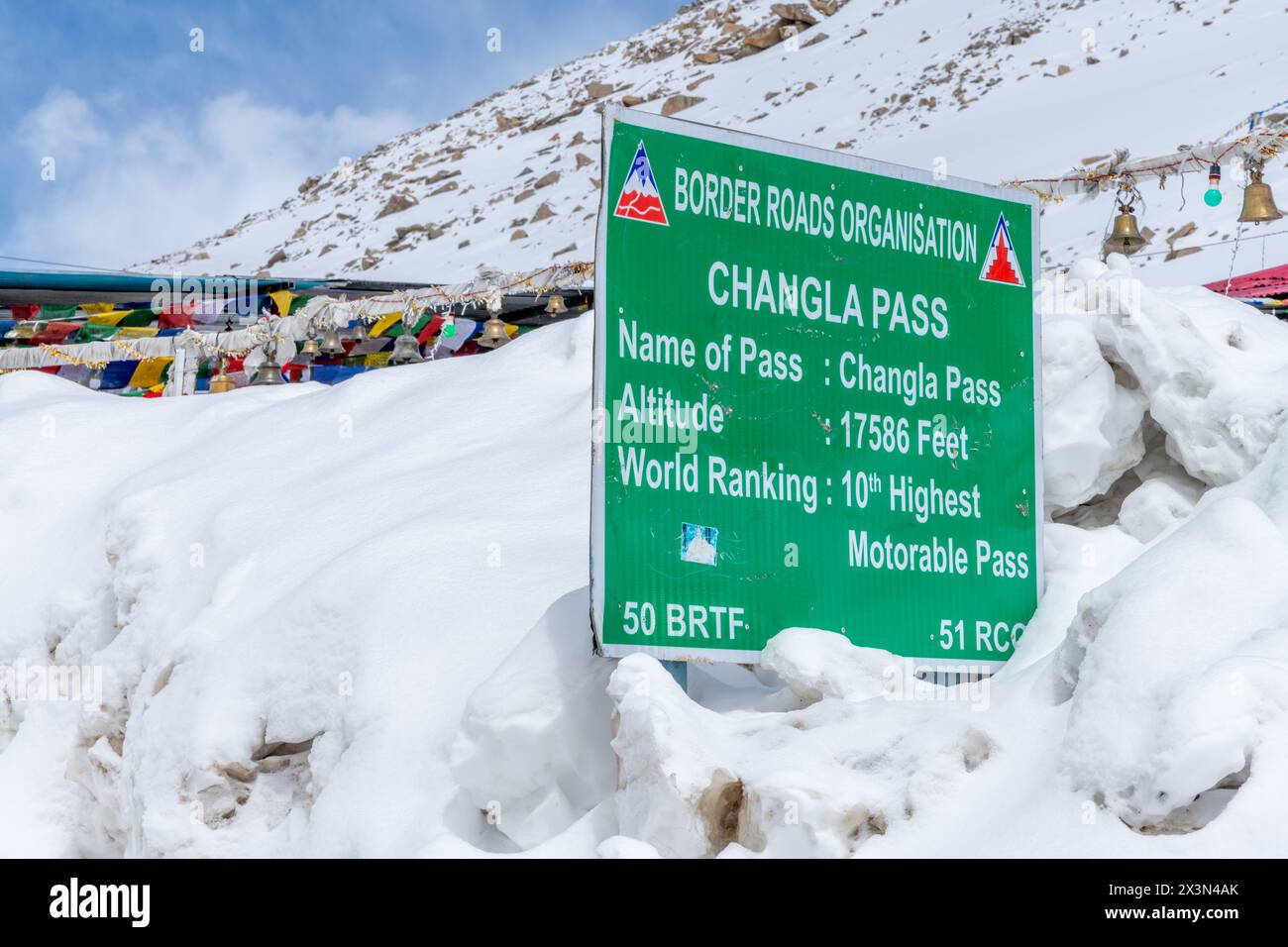 Sign at the summit of the Chang La mountain pass at 17,590 feet in the northern Indian Himalayas ...