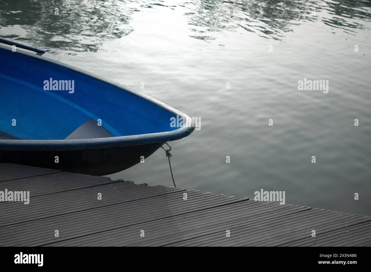 Little blue boat on the pier . Close up blue boat on the lake. Copy ...