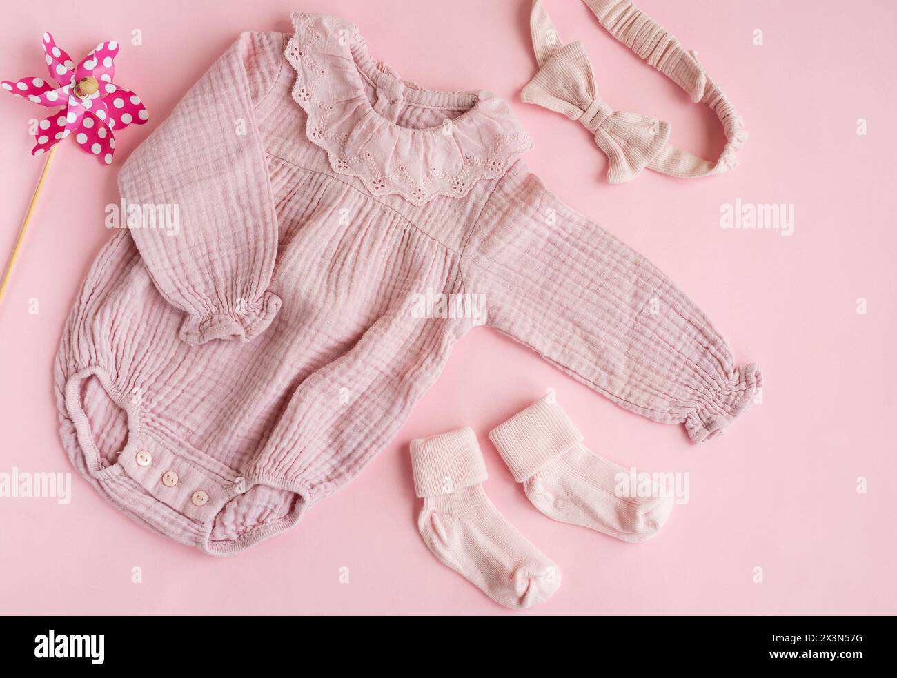 Set of pink clothes and accessories for newborn baby. Baby shower concept. Flat lay, top view ...