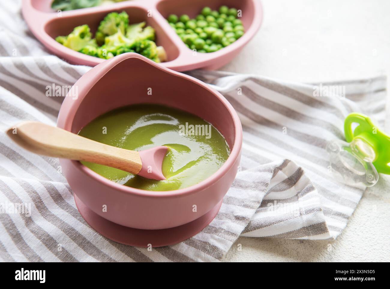 Healthy baby food in bowl. Baby food vegetable puree with broccoli and ...