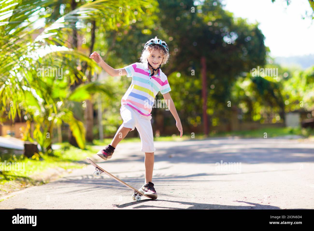 Kid with skateboard. Child riding skate board. Healthy sport and ...