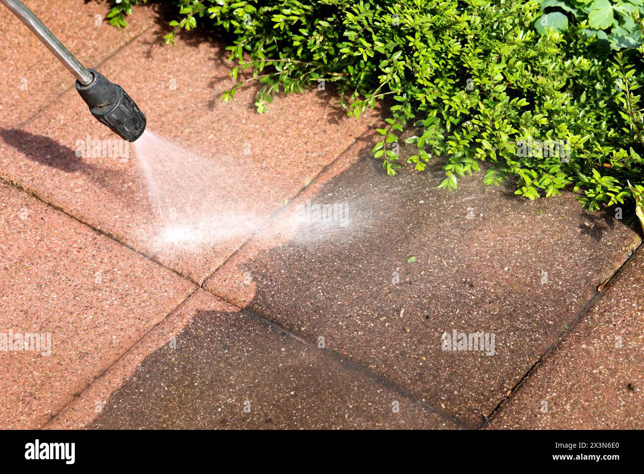 Cleaning stone patio slabs with high pressure Stock Photo - Alamy