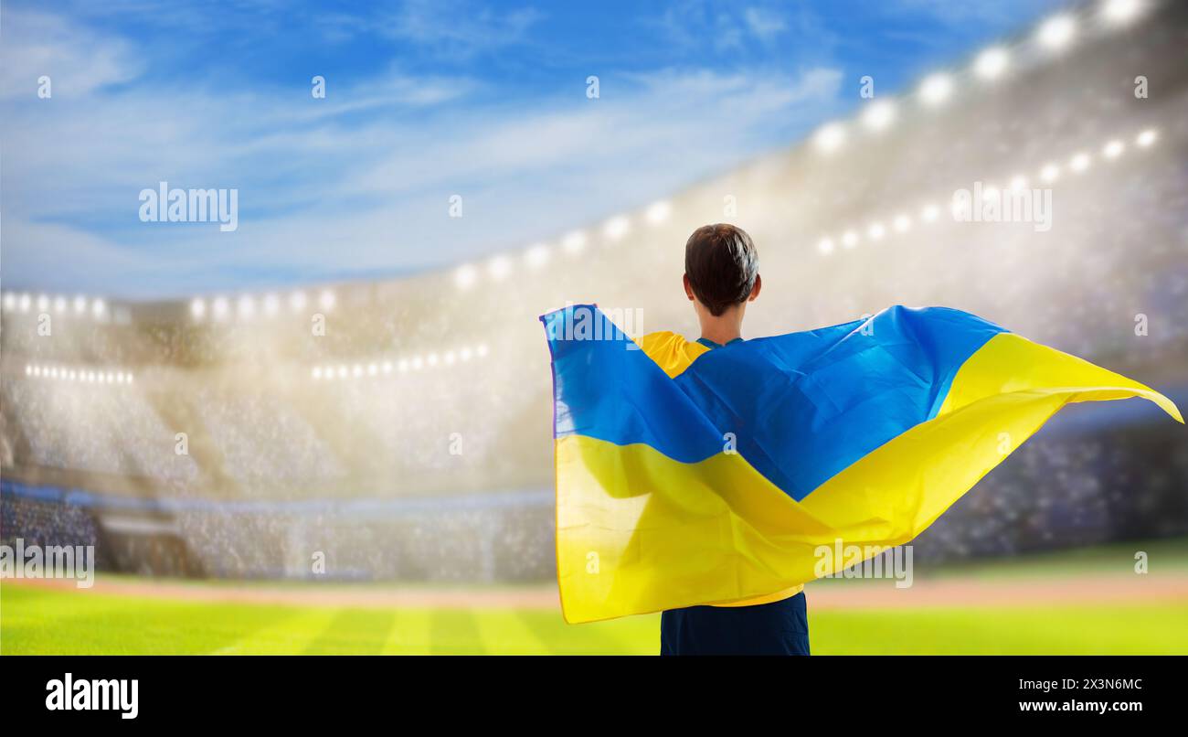 Ukraine football supporter on stadium. Ukrainian fans on soccer pitch ...