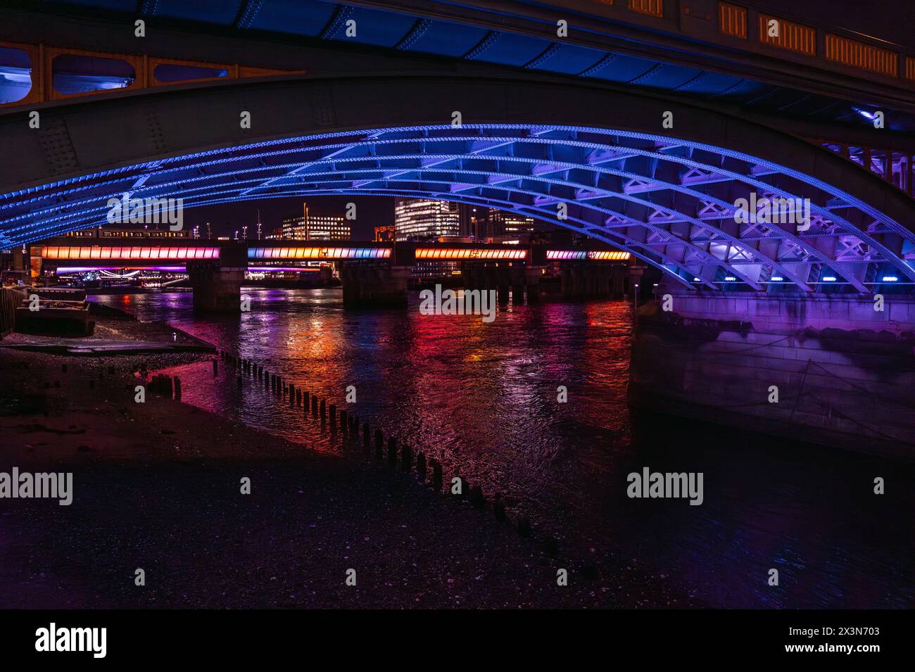 Steel structure of the lower part of a London Bridge illuminated in ...