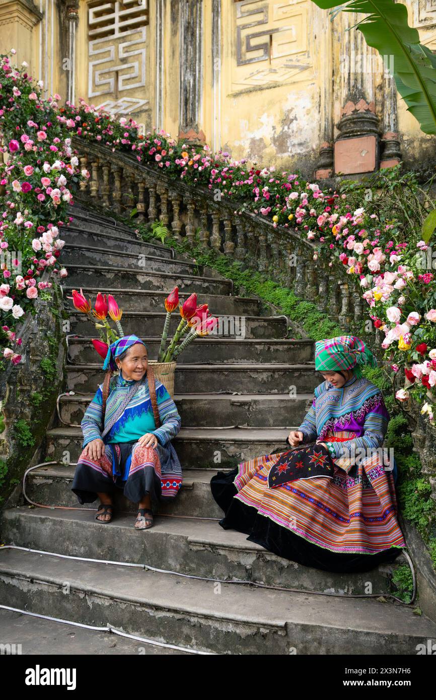 Flower Hmong women sitting on the stairs of the Hmong Kings Palace (Vau ...