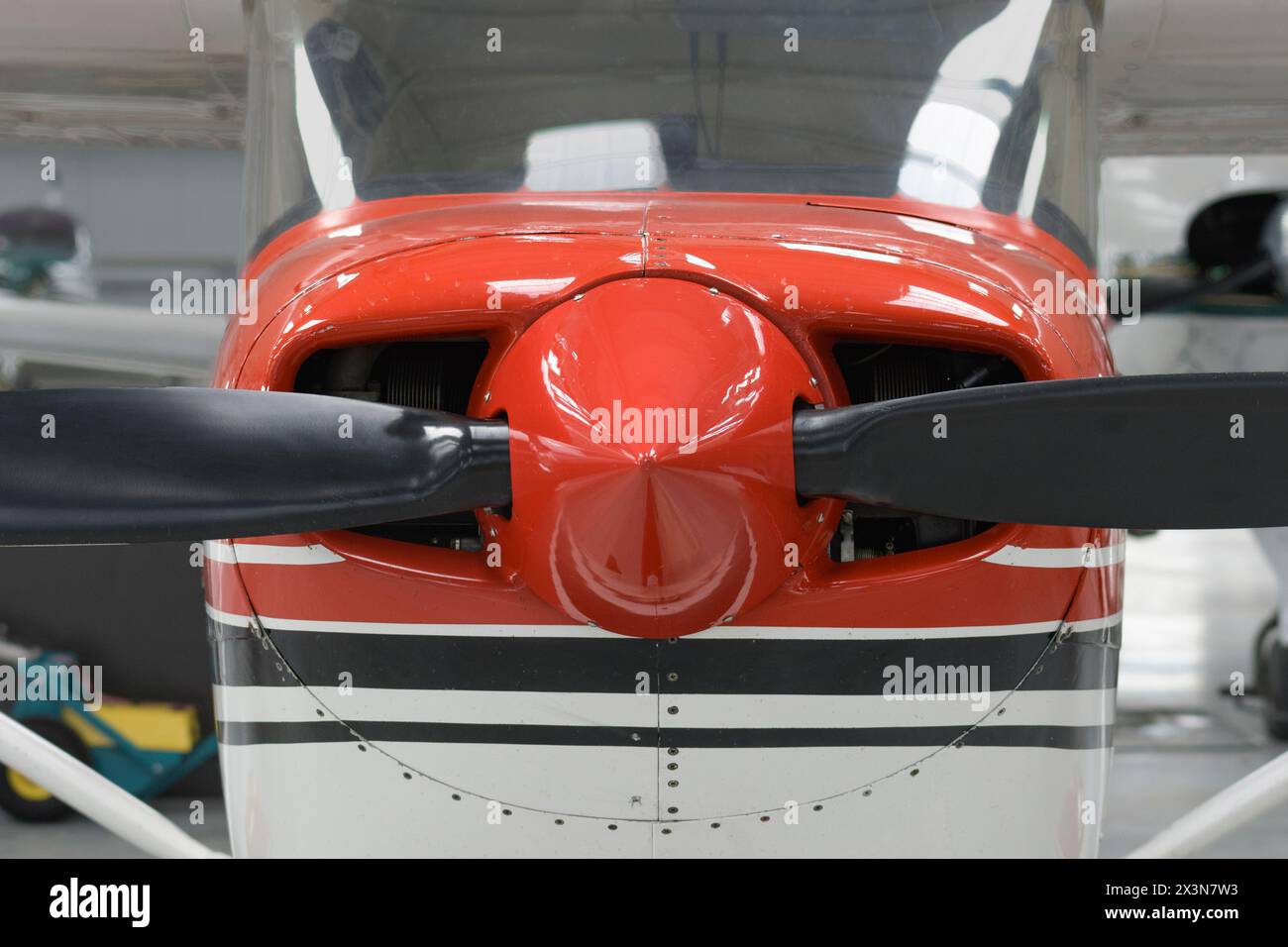 Front part of a red light aircraft with a propeller. Screws, texture ...