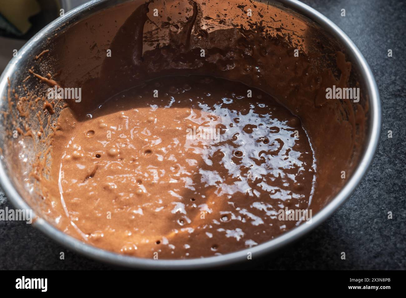 Chocolate cupcake mix inside metal mixing bowl closeup Stock Photo - Alamy