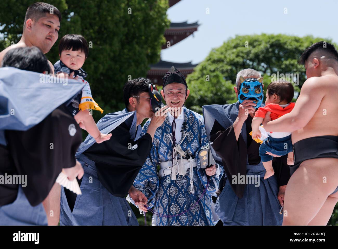 Tokyo, Japan. 28th Apr, 2024. Sumo wrestlers hold children during the ...