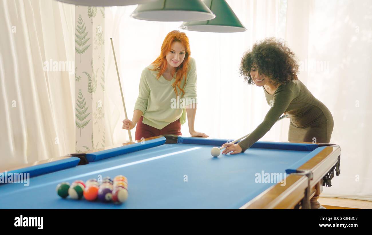 Women starting to play pool at home Stock Photo - Alamy