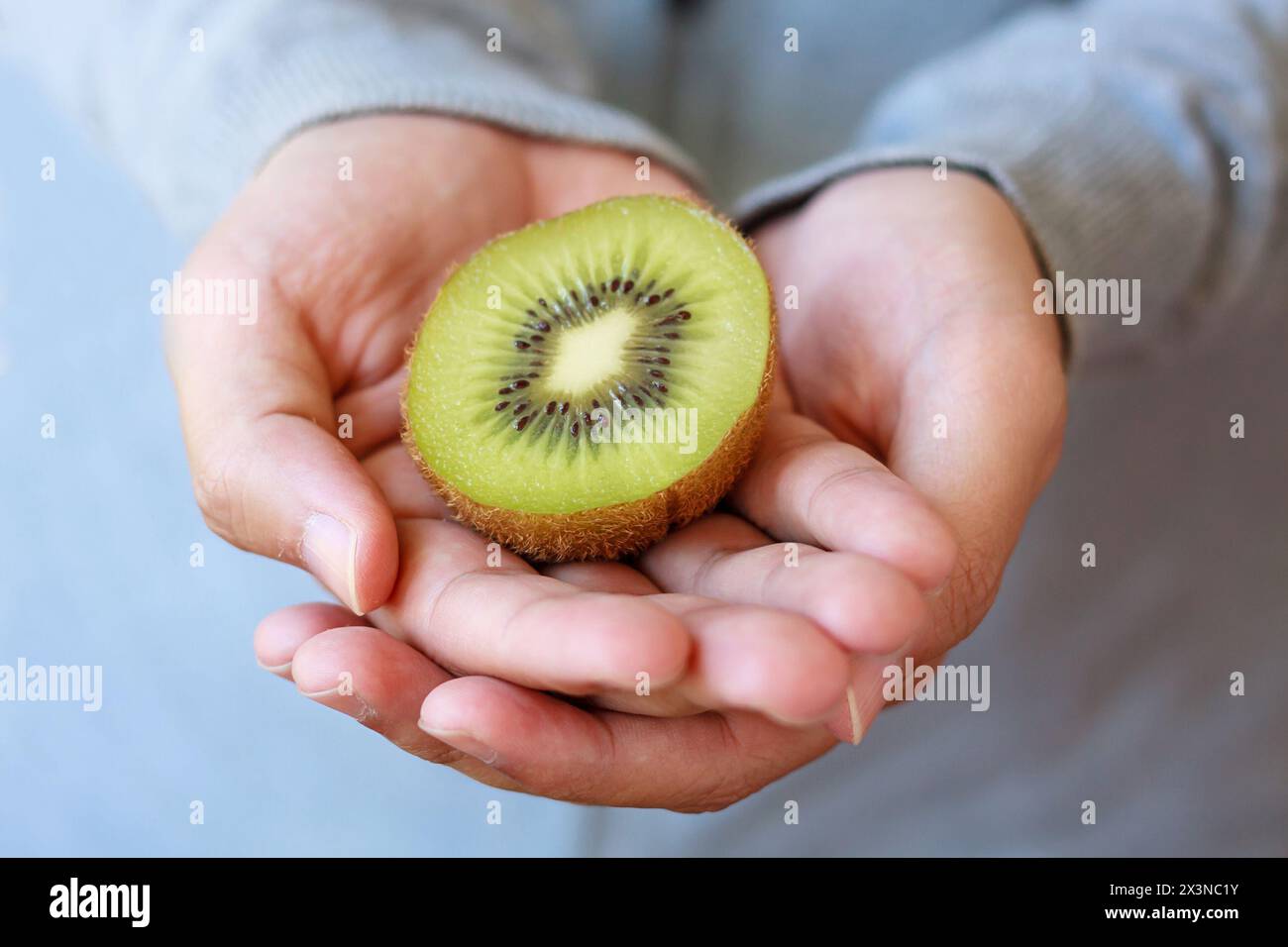 Woman holding fresh kiwi hands hi-res stock photography and images - Alamy
