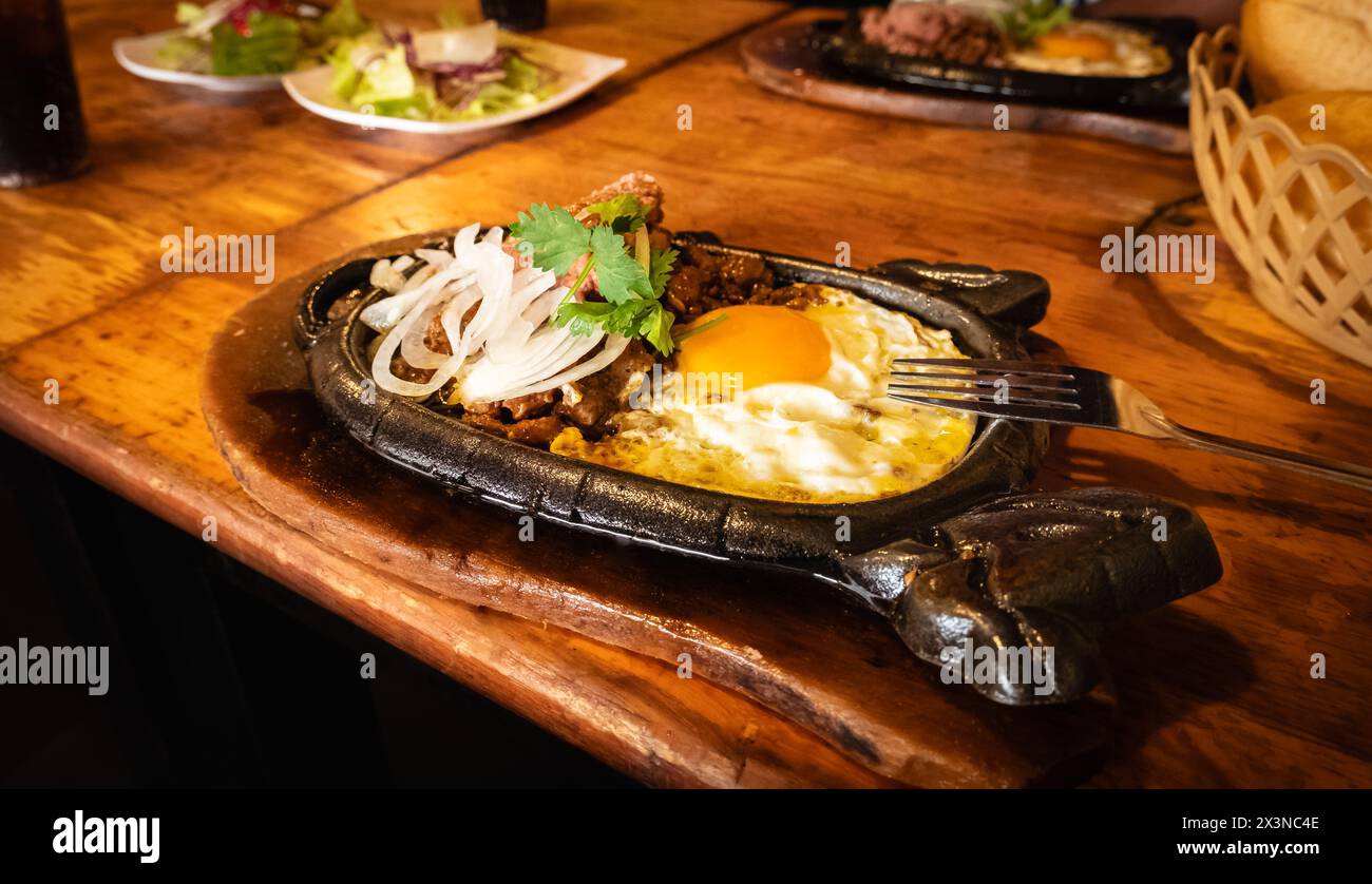 Bo ne trung, beef cooked in a hot plate with gravy and eggs vietnamese ...