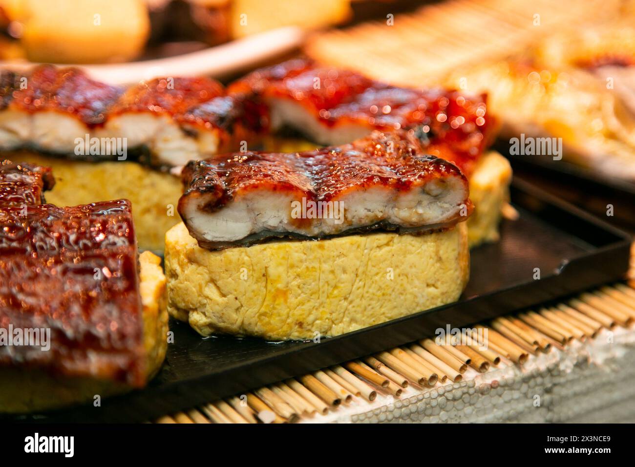 Roasted skewered eel at a food market in the city of Osaka in Japan ...