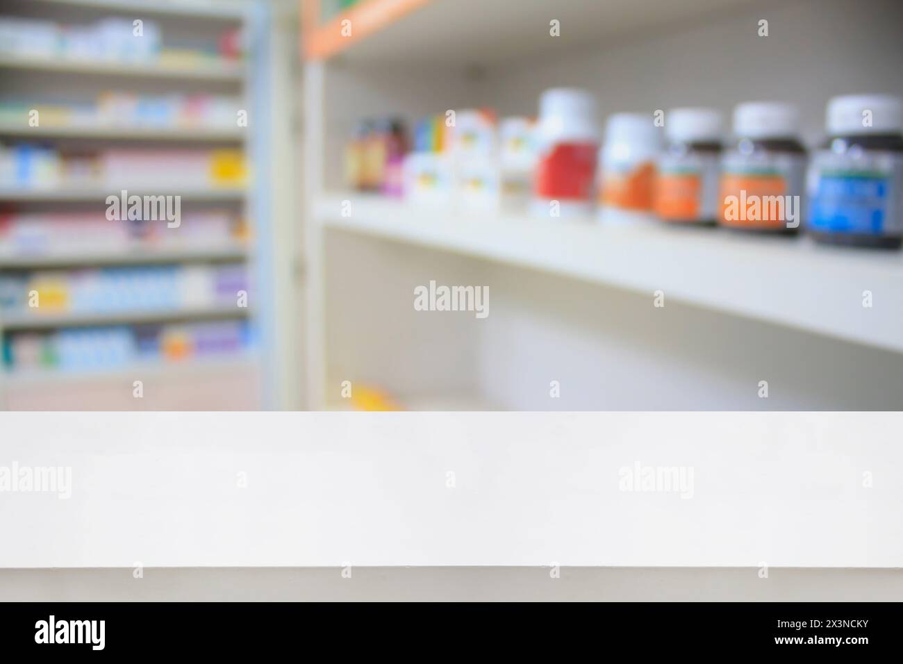 pharmacy table counter with blur shelves of drugs in the pharmacy shop ...