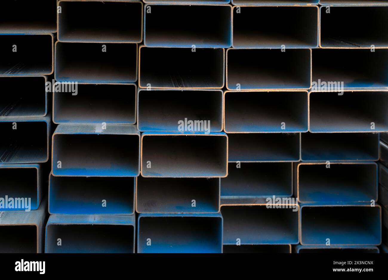 Industrial warehouse stock of rectangular metal pipes for building and construction supplies ...