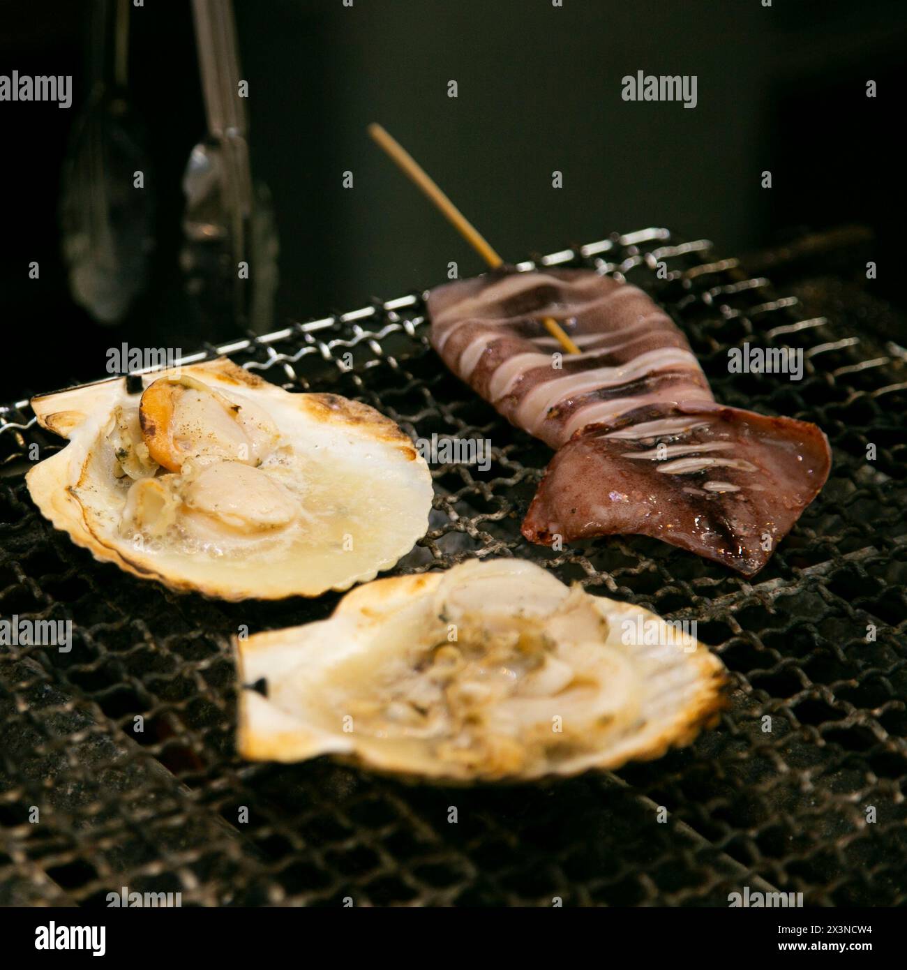 Seafood shell and fish cooked on a grill at the Osaka fish market in ...