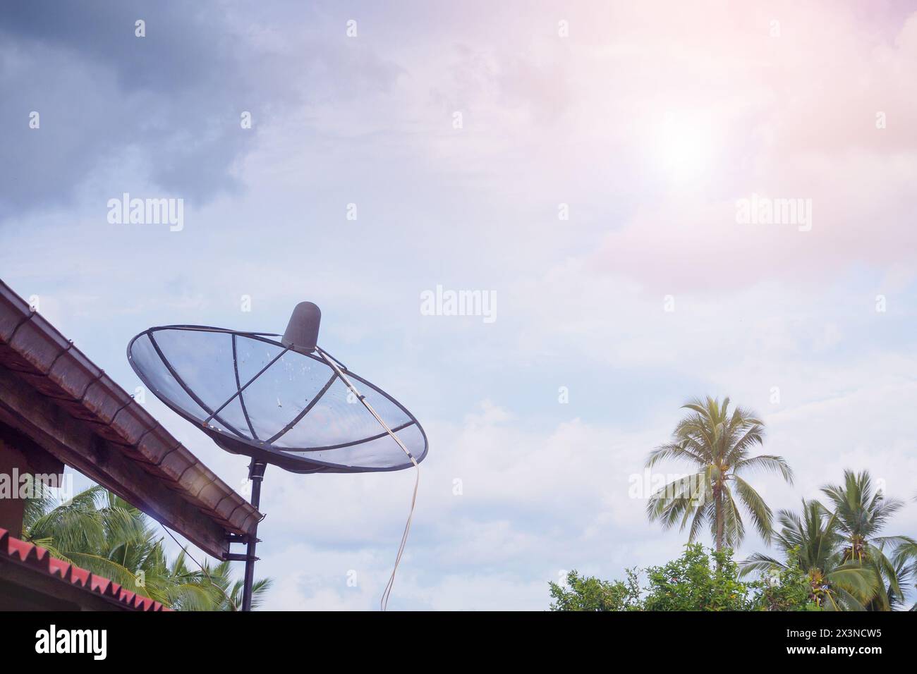 TV Satellite dish antenna on the roof house in rural with sky clouds ...