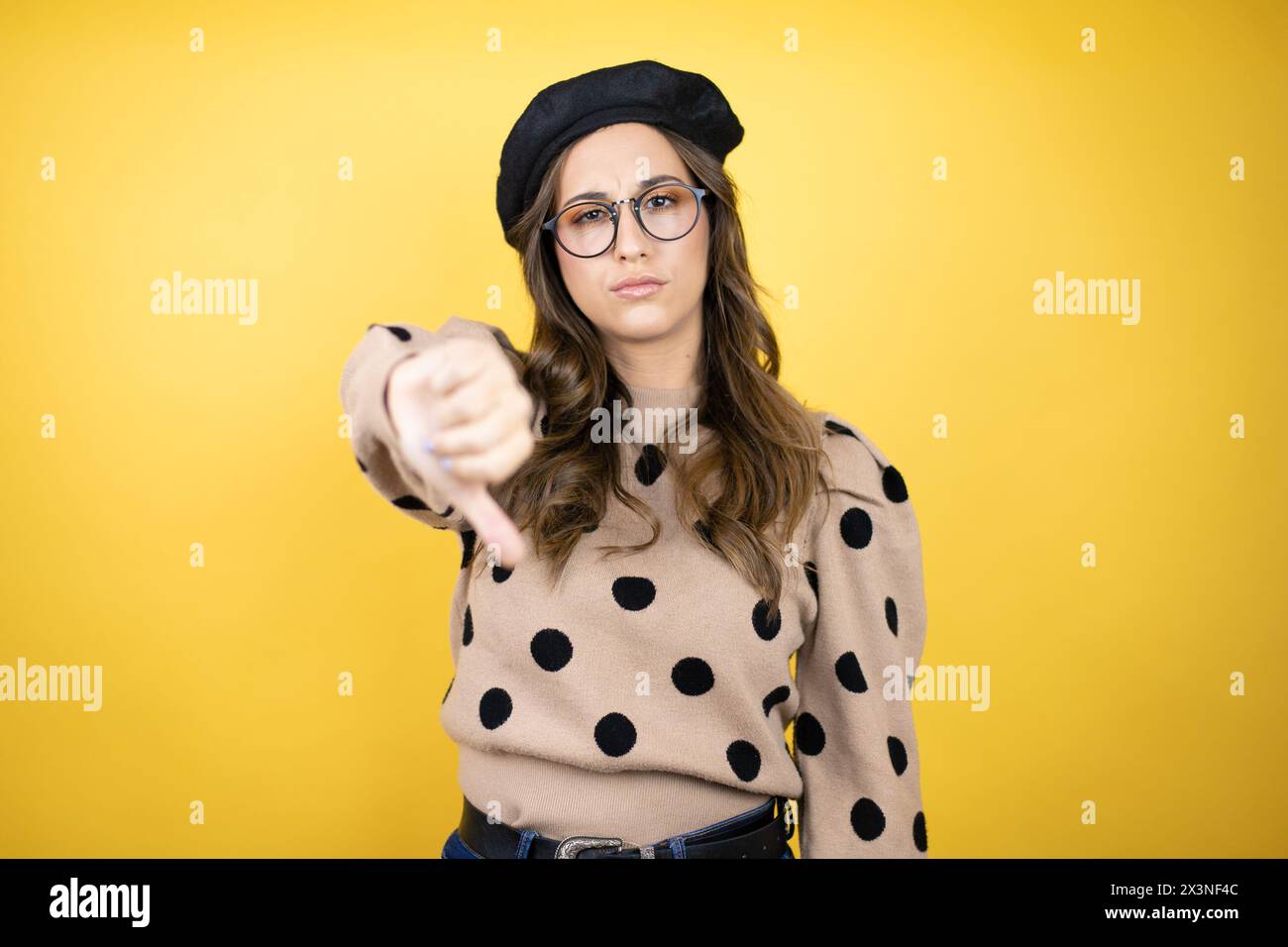 Young beautiful brunette woman wearing french beret and glasses over ...