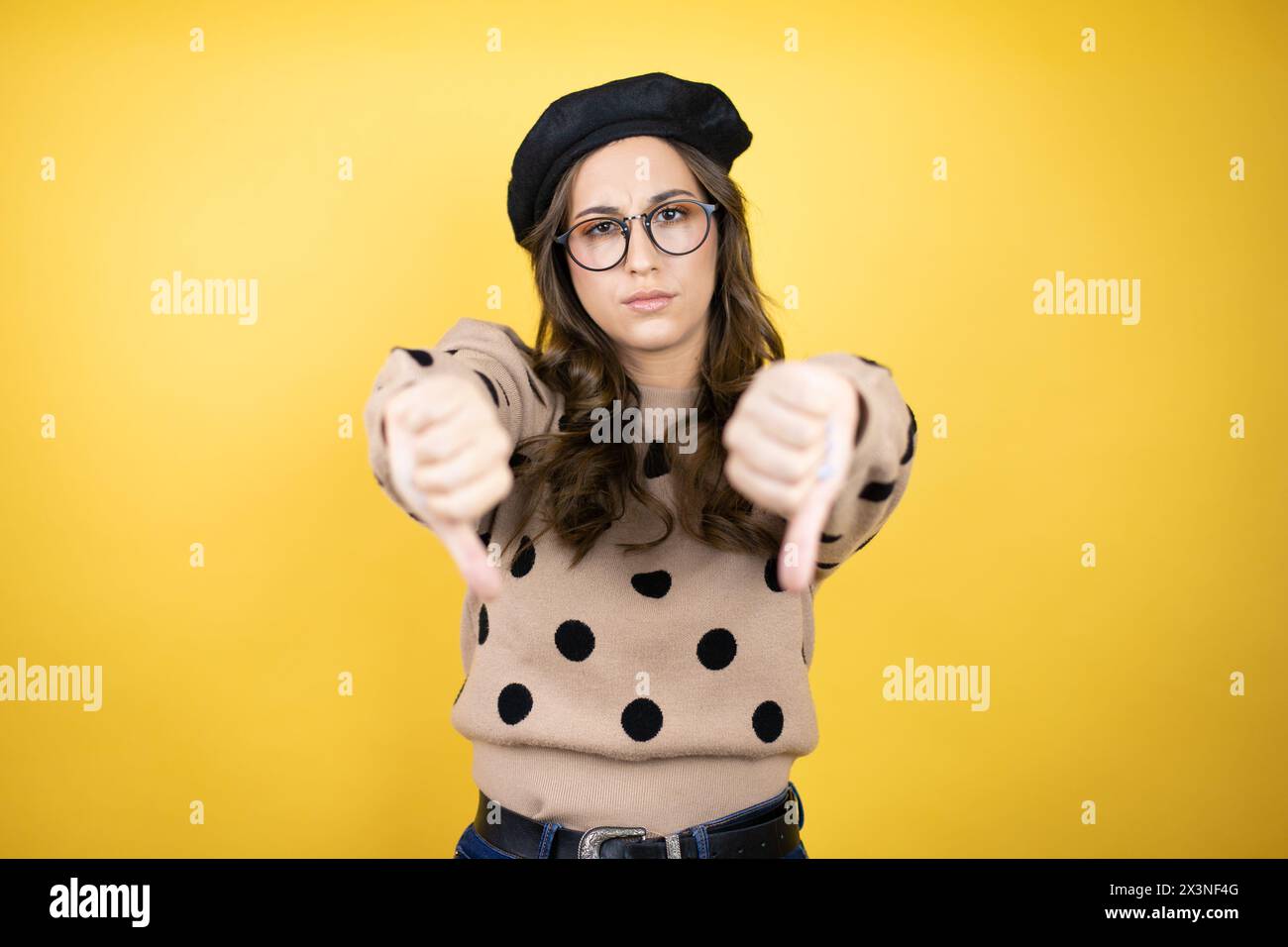 Young beautiful brunette woman wearing french beret and glasses over ...
