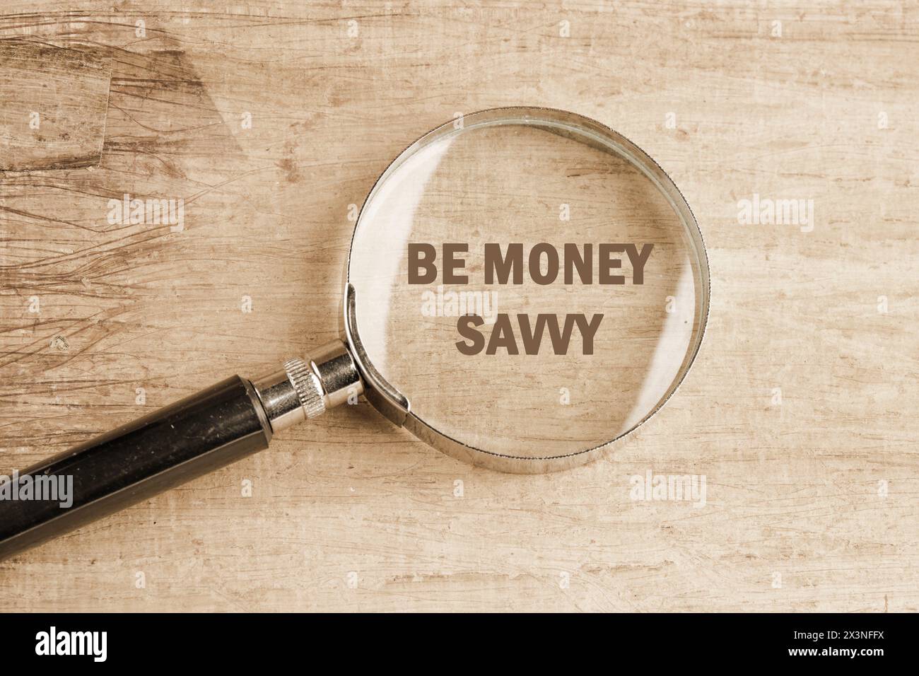 Savings concept,Text Be money savvy visible through a magnifying glass ...