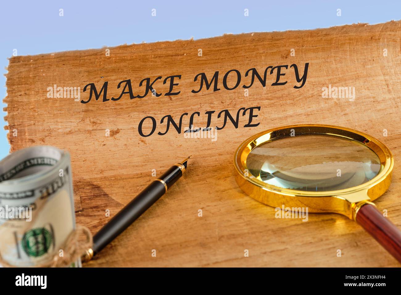Business concept. MAKE MONEY ONLINE lettering written on papyrus next ...