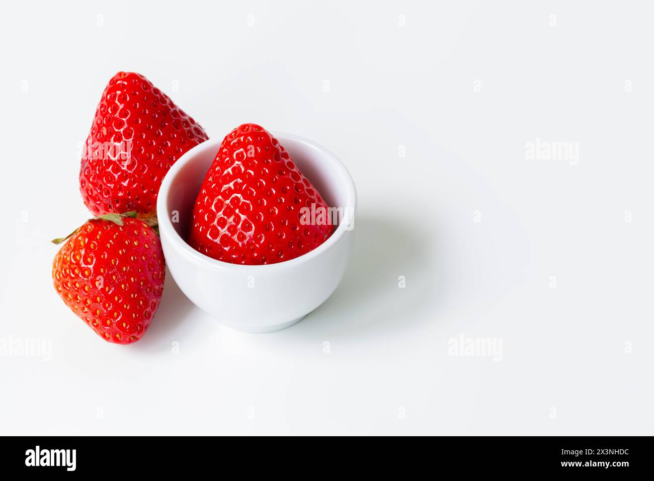Bright red strawberries against a pure white background Stock Photo - Alamy